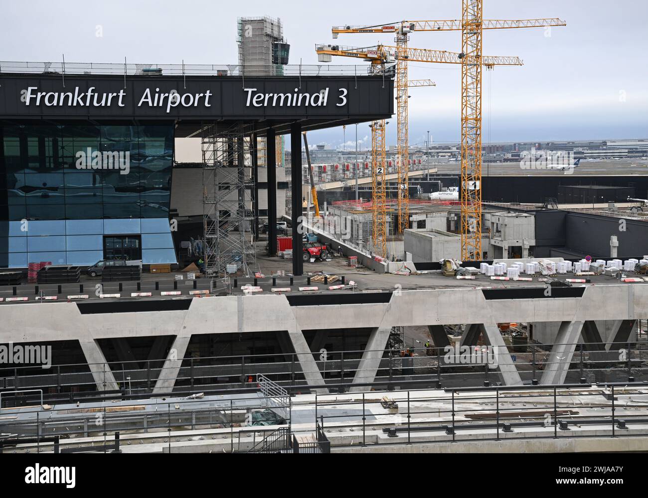 14 February 2024, Hesse, Frankfurt/Main: Construction cranes stand at ...