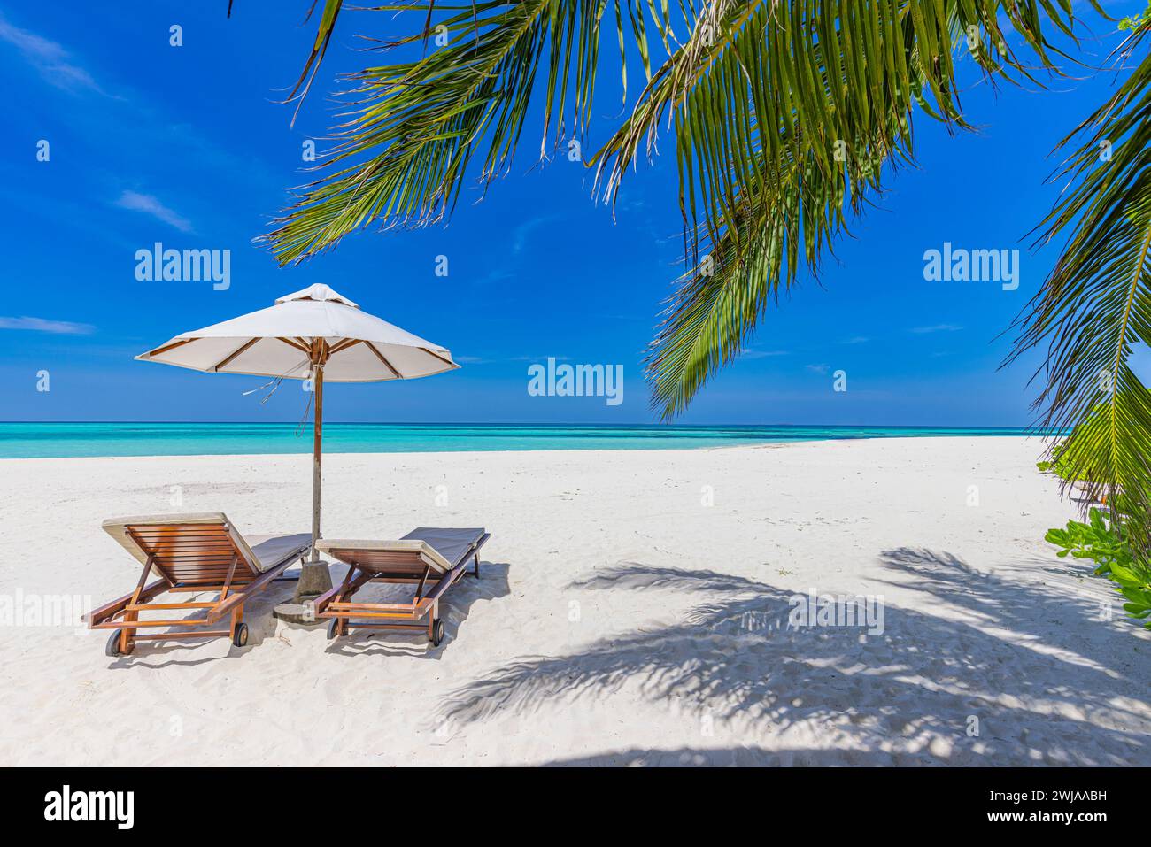 Beautiful tropical island scenery, two sun beds, loungers, umbrella ...