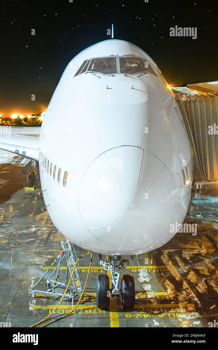 generic modern passenger aircraft at the gate by night ready for ...