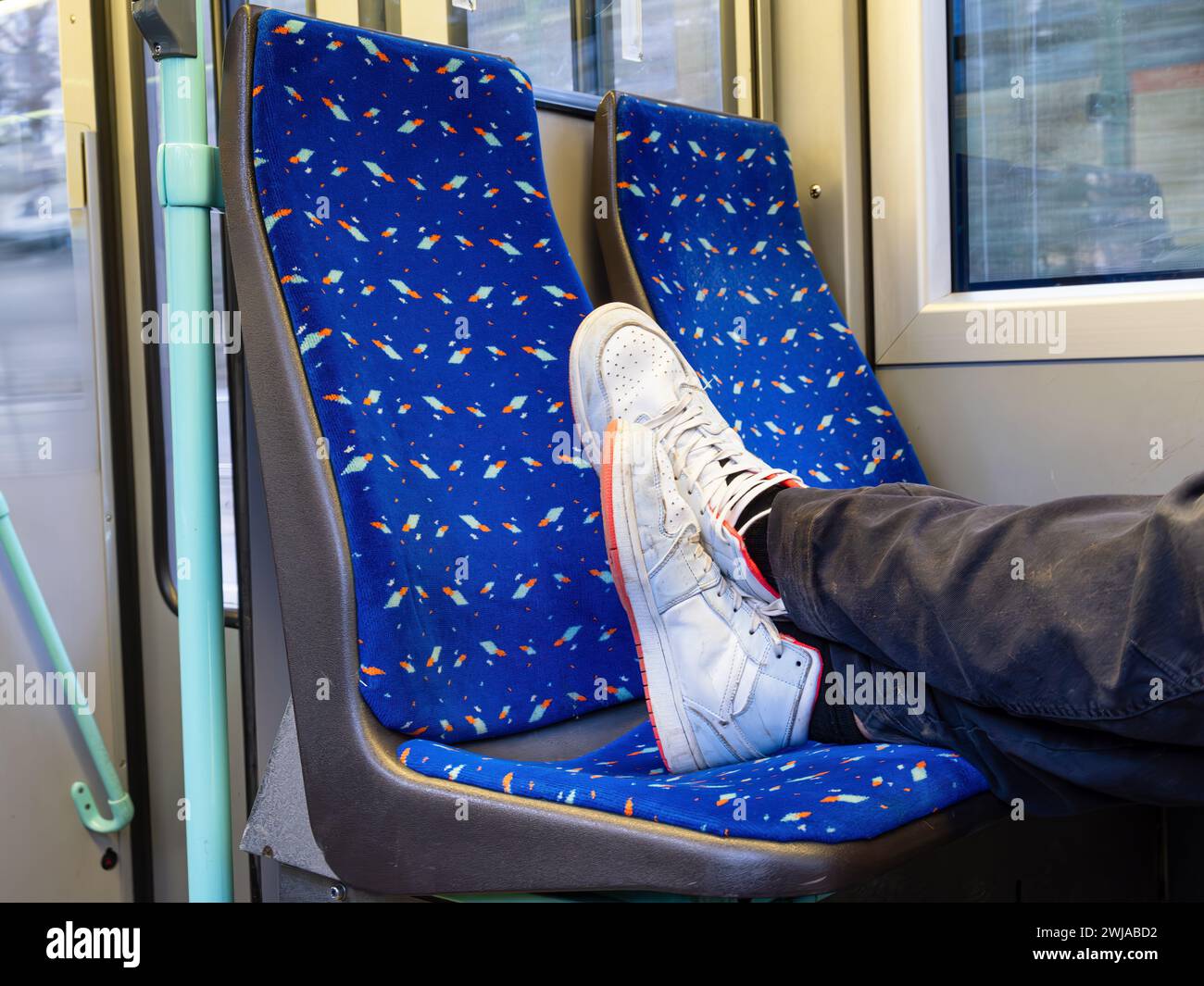 An impolite and uneducated young person placed her feet on the seat of ...