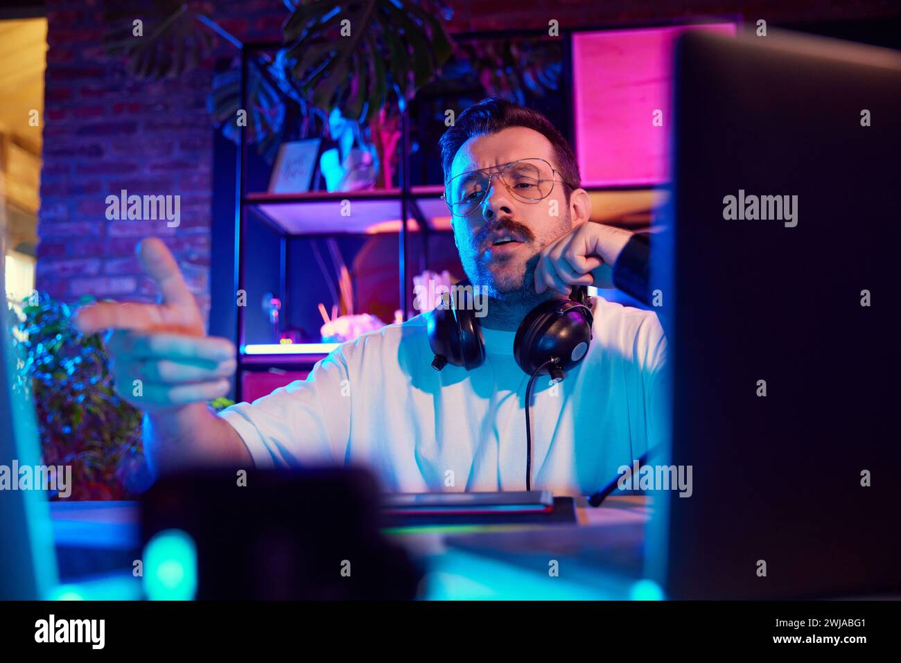 portrait of streamer with professional microphone setup interacting ...