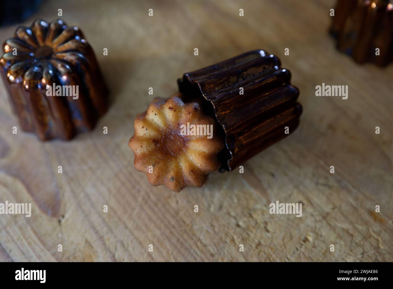 Specialty pastries from Bordeaux. Cannelé Bordelais traditional copper ...