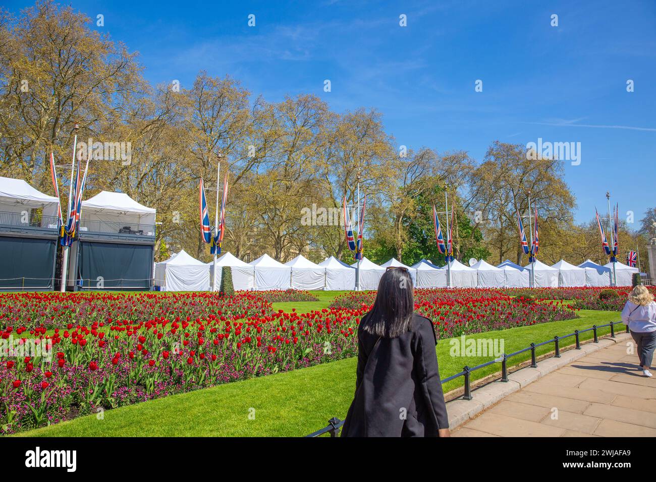 People walk past tents put up near Buckingham Palace as London prepares ...
