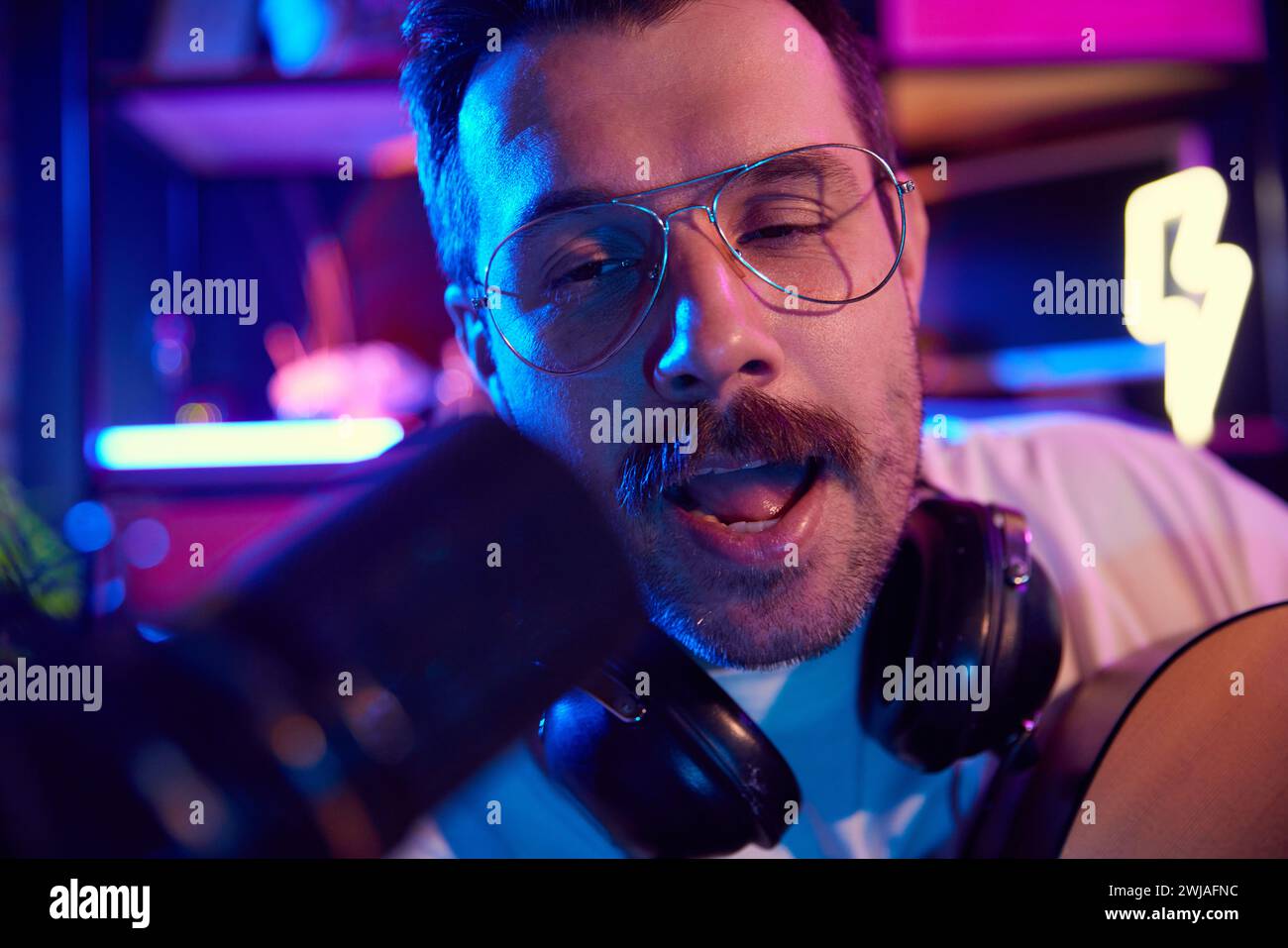 Close up photo of joyful young man, artist creating music with acoustic ...