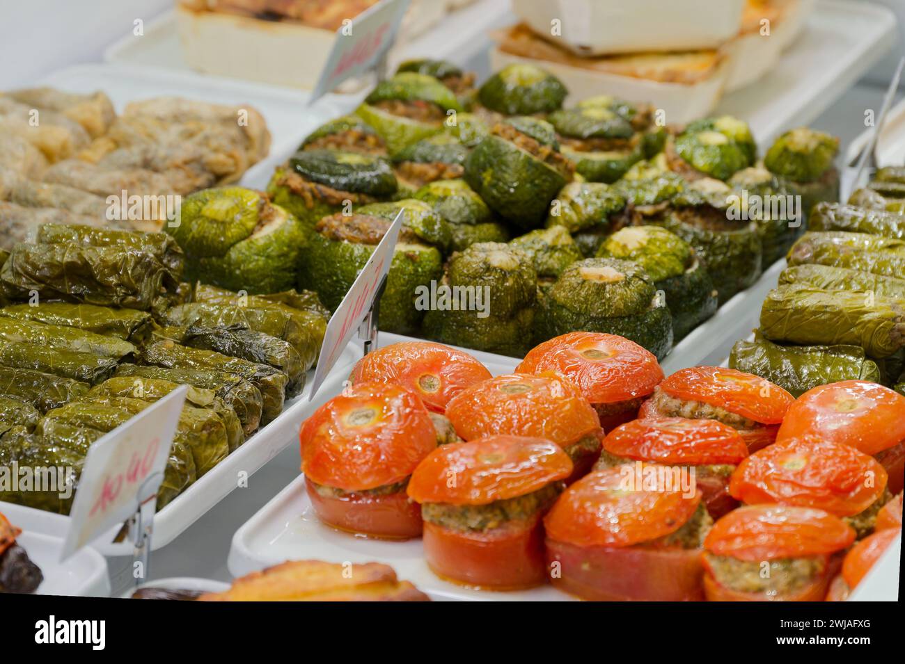 Stuffed tomatoes and zucchinis in the fresh deli counter of a Monoprix ...