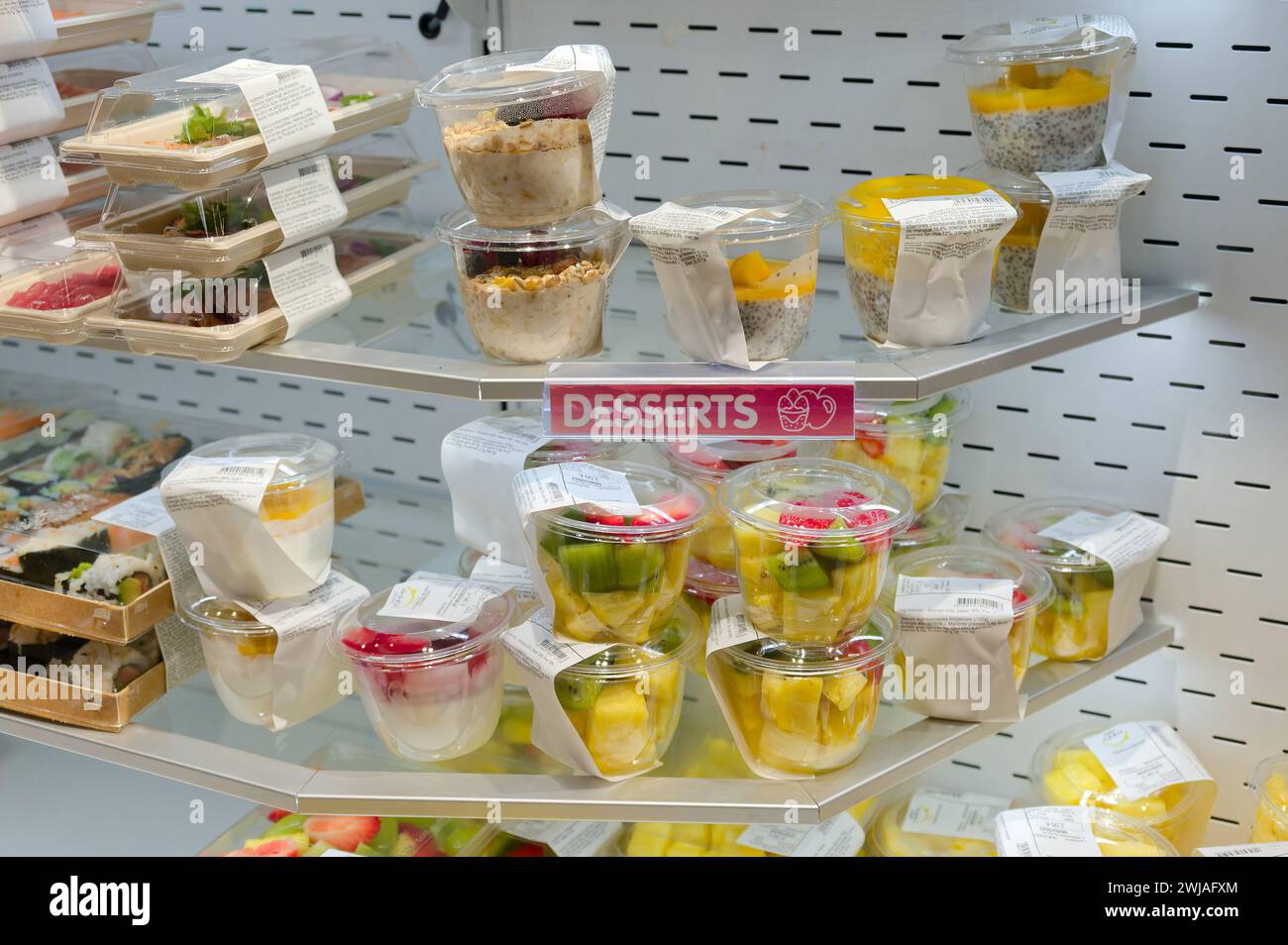 Desserts, yogurt and cut fruits in plastic packaging in the fresh ...