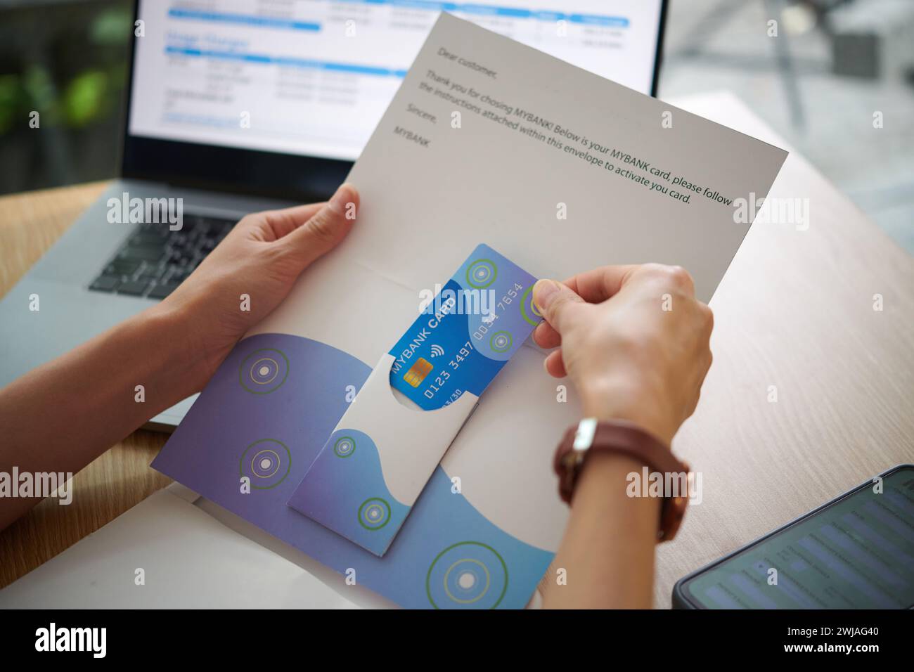 Hands of woman opening bank letter and taking out credit card Stock ...