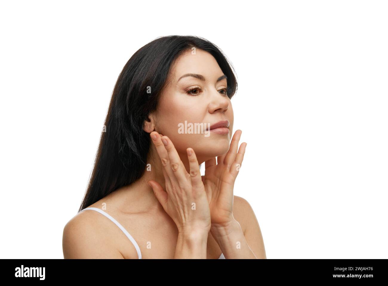 Beautiful woman, 40s years old age looking away and touching her face ...