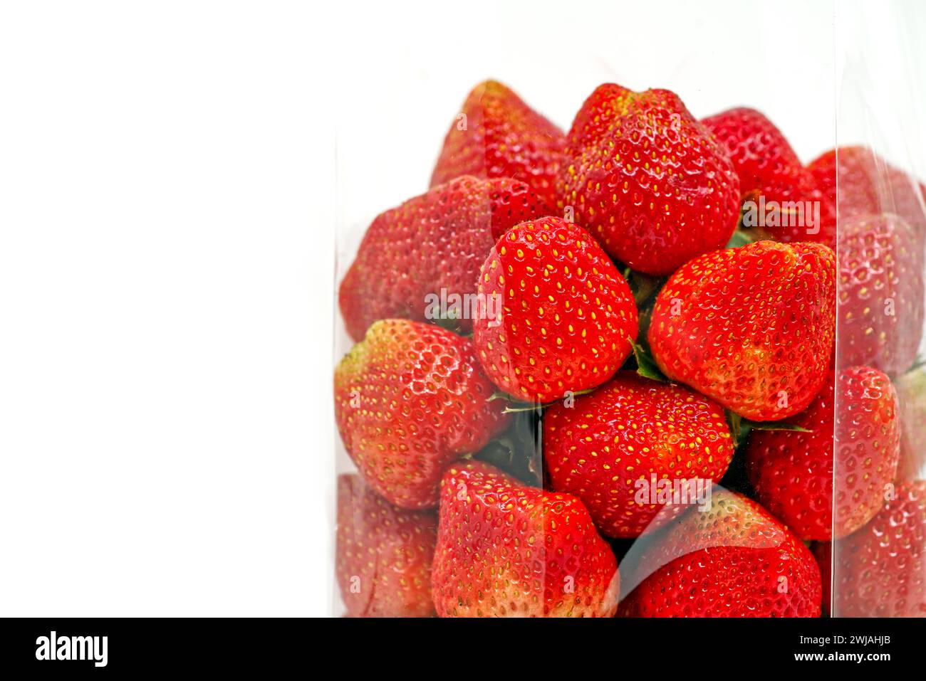 Close-up strawberries in cleared plastic bag on white background, many ...