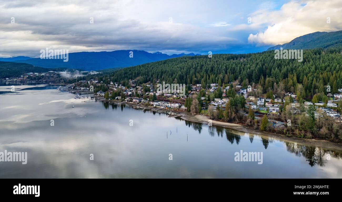 Scenic lakeside homes nestled amidst lush trees and majestic mountains ...