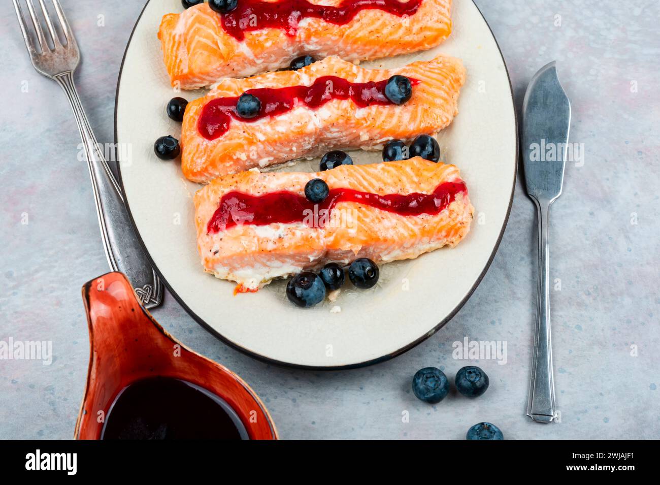 Fried tasty salmon fillet with blueberry berry sauce. Healthy food ...