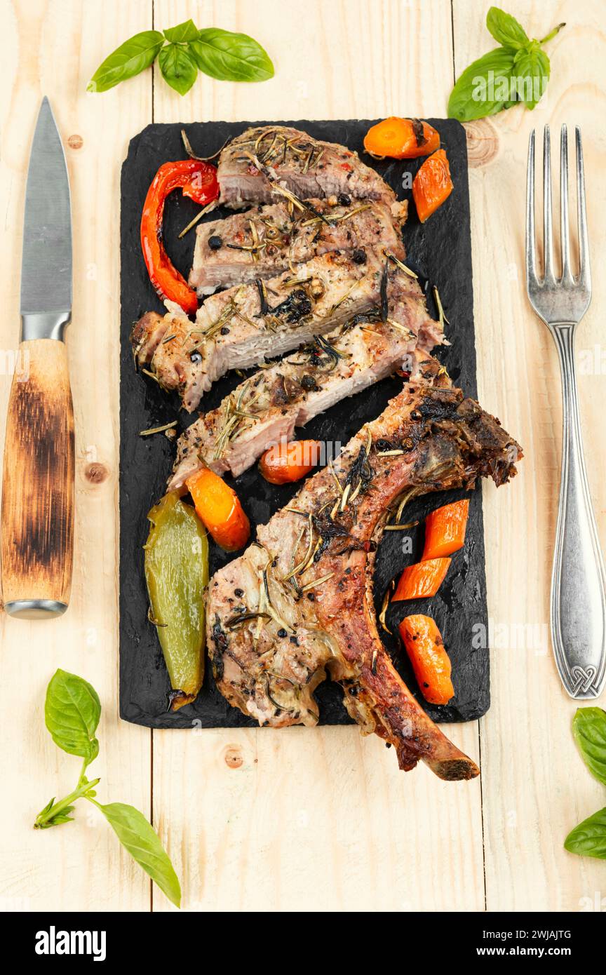 Sliced pork chop tomahawk. Fried tomahawk pork meat steak. BBQ. Rustic ...