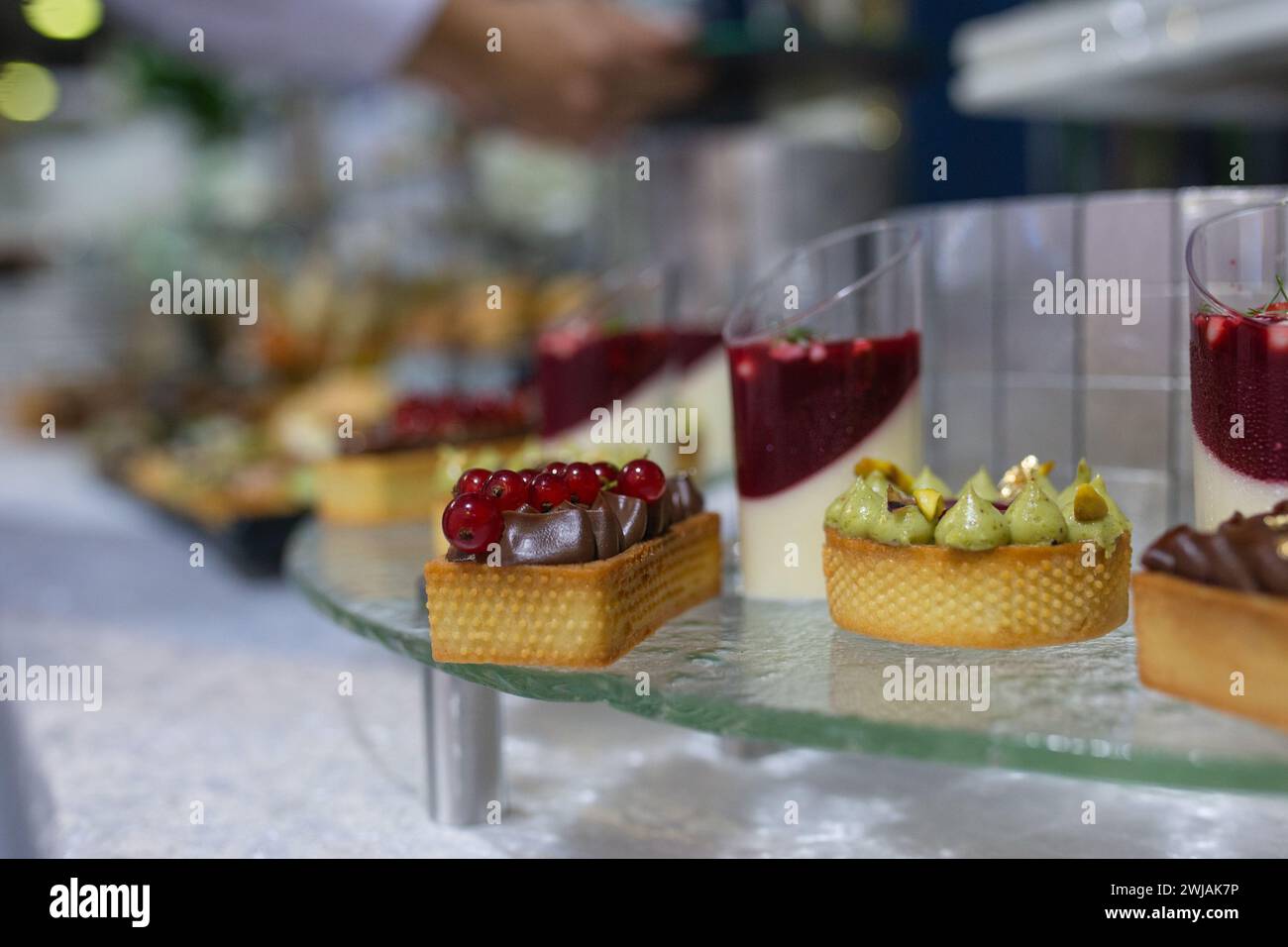 Variety of sweet and savory canapes and desserts displayed on glass ...