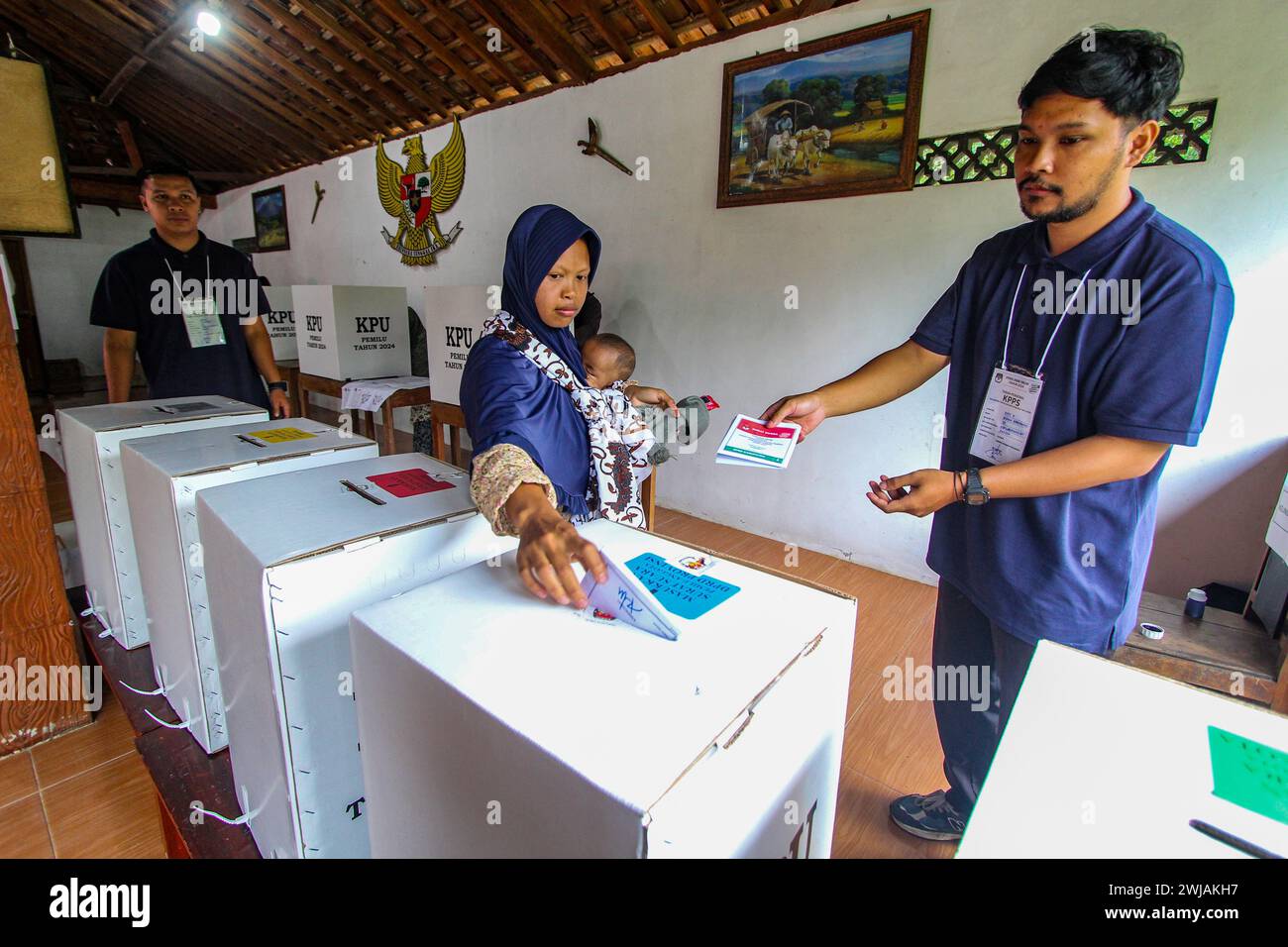 February 14, 2024: A voter casts a ballot in the Indonesian election in ...