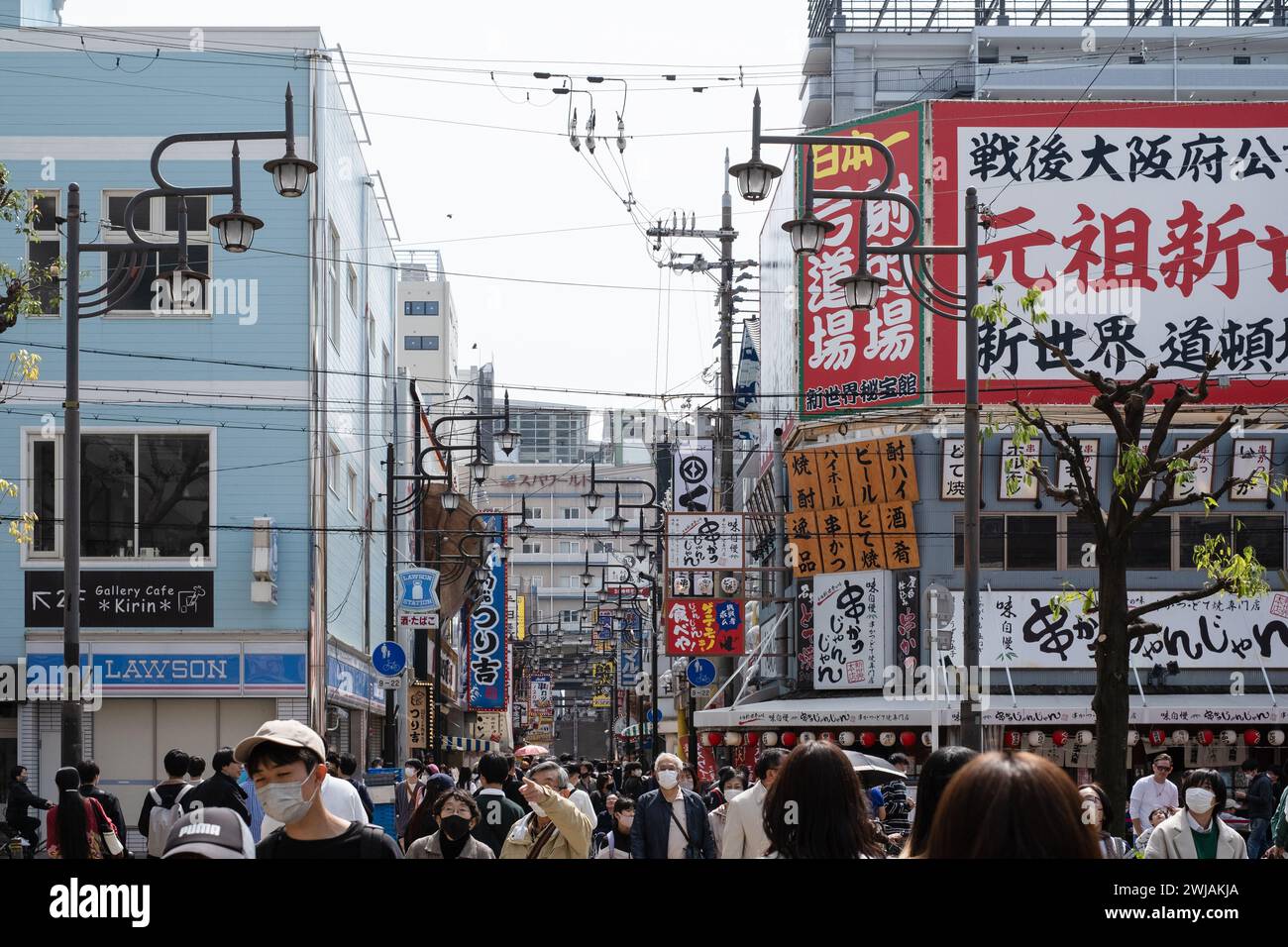 A busy street near Tsūtenkaku, Tower Reaching Heaven, Shinsekai ...