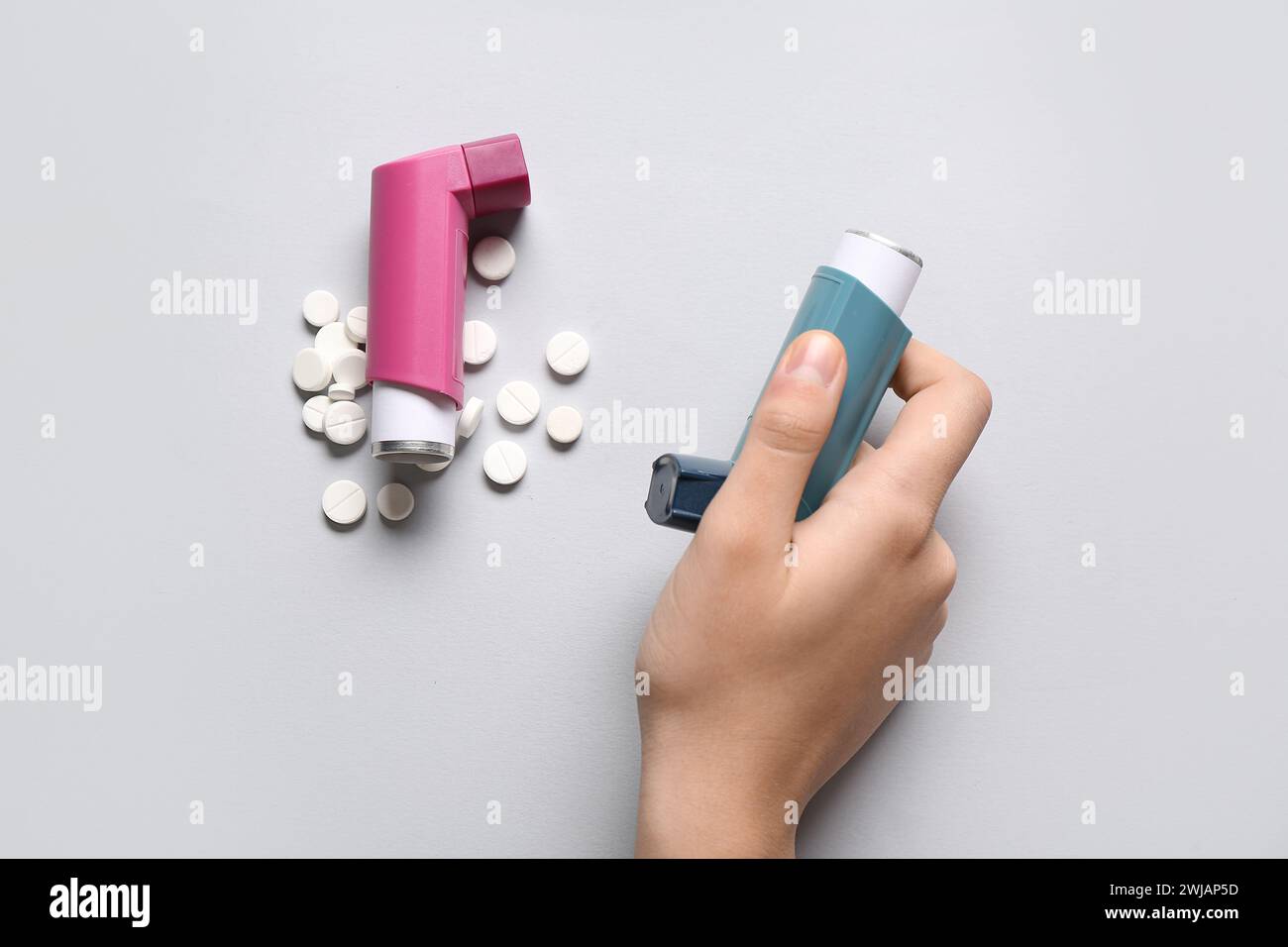 Child's hand with asthma inhalers and pills on white background Stock ...