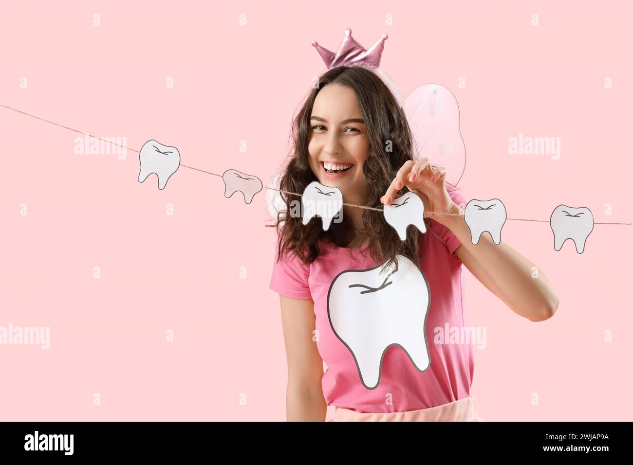 Tooth Fairy with paper teeth on pink background Stock Photo - Alamy