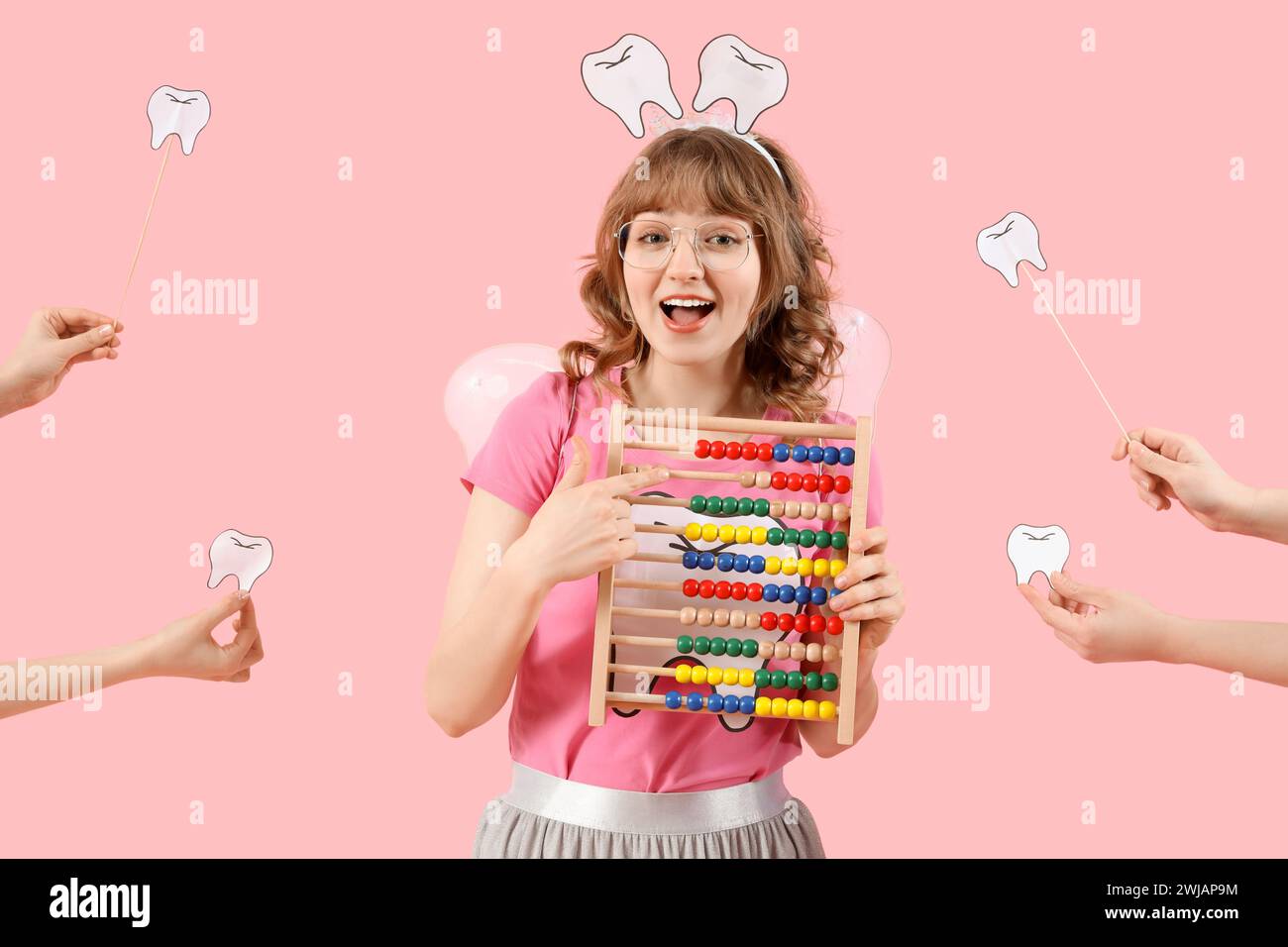 Tooth Fairy holding abacus and hands with paper teeth on pink ...