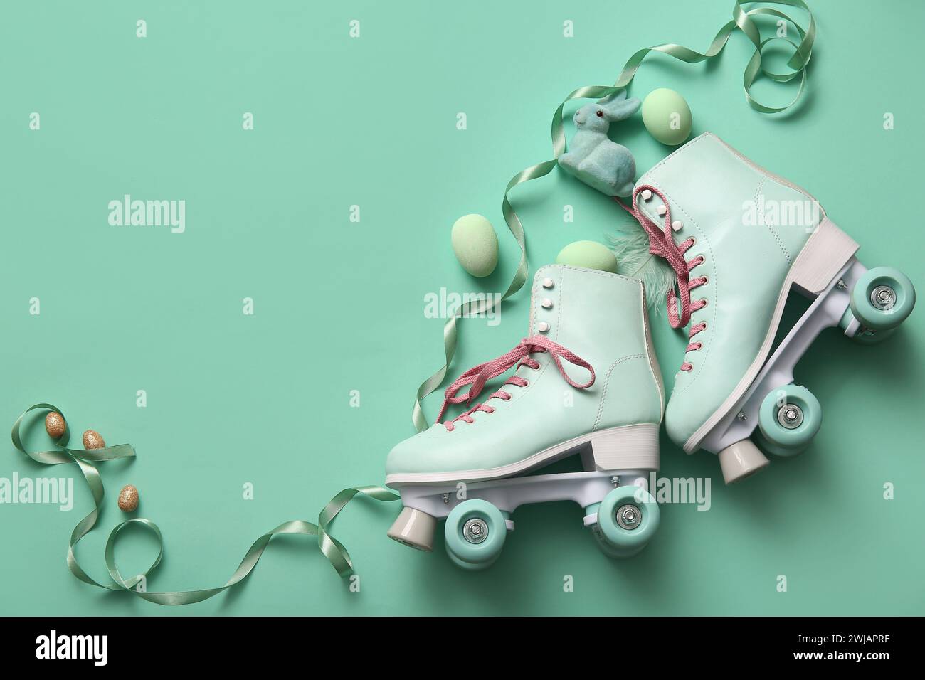 Vintage roller skates with Easter eggs and toy bunny on green ...