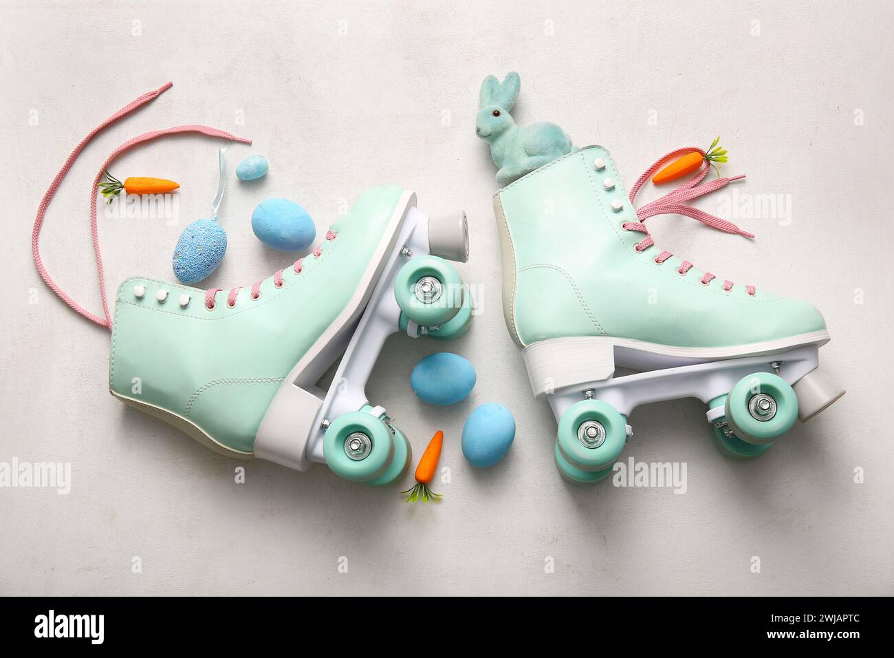 Vintage roller skates with Easter eggs, toy bunny and carrots on white ...