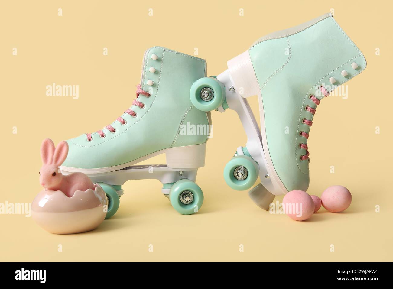 Vintage roller skates with Easter eggs and toy bunny on yellow ...
