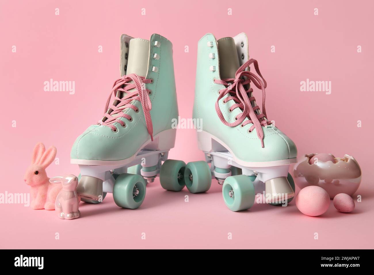Vintage roller skates with Easter eggs and toys bunny on pink ...