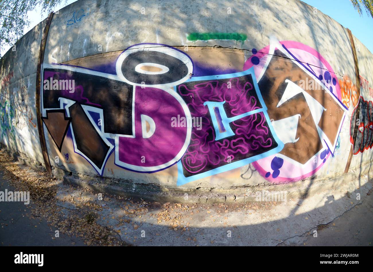 Fisheye shot of street art graffiti drawing on wall. Spray art artwork ...