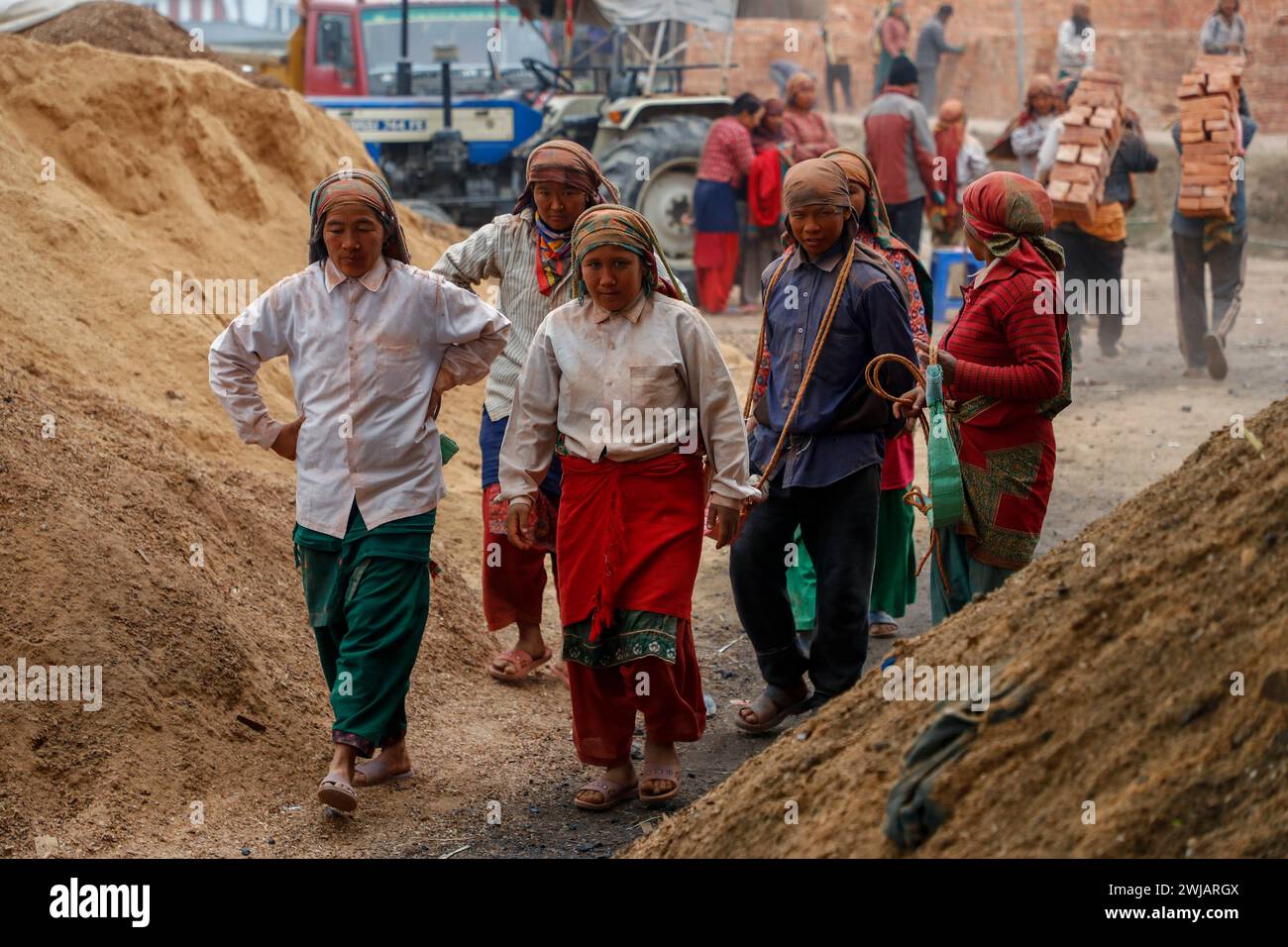 Amrita Gharti 24-years old, walks with her friends to collect bricks ...