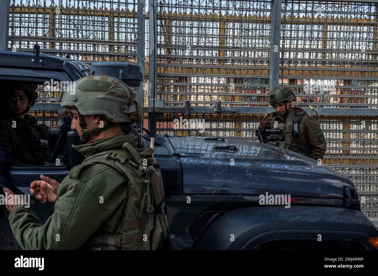 Nitzana, Israel. 14th Feb, 2024. Israeli soldiers stand guard as ...