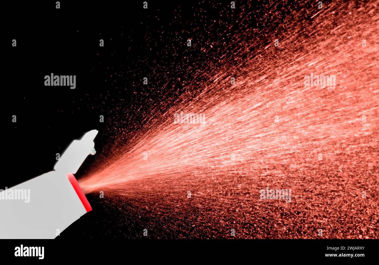 A fine spray of glass cleaner, colored against black background Stock ...