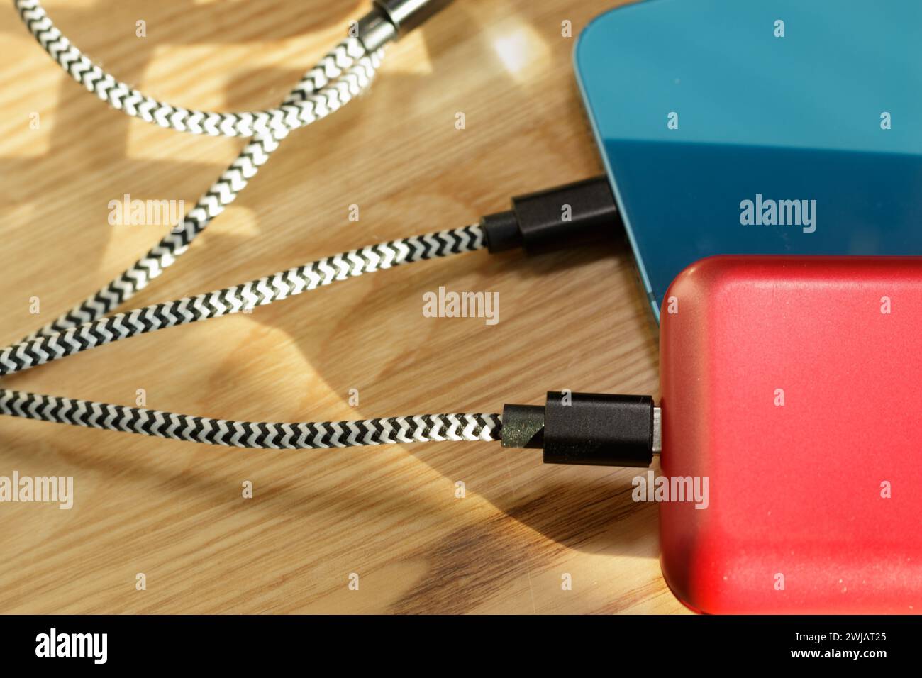 3-in-1 mobile charging cables plugged into cellphones Stock Photo - Alamy