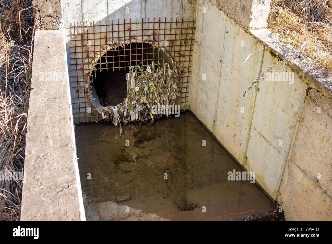 Storm sewer pipe closed with grating. Broken sewer entrance. Plastic ...