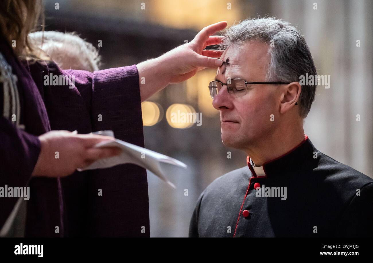 Canon Claire Renshaw makes an ash cross on the forehead of the Very ...