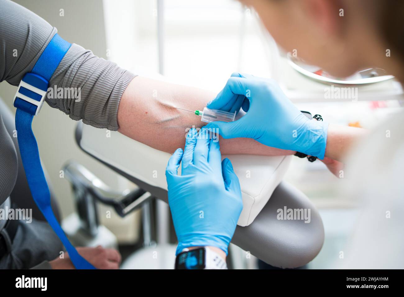 A nurse in the lab takes a blood test from a vein, a close-up plan ...