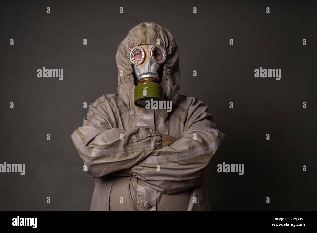 soldier in a protective suit with a gas mask during a disaster drill ...