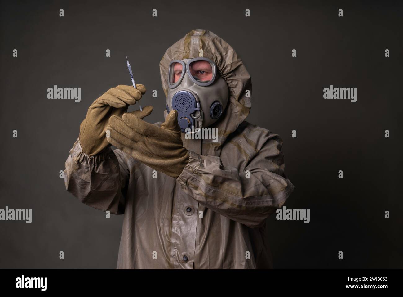 soldier in a protective suit with a gas mask during a disaster drill ...