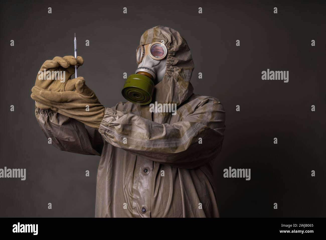 soldier in a protective suit with a gas mask during a disaster drill ...
