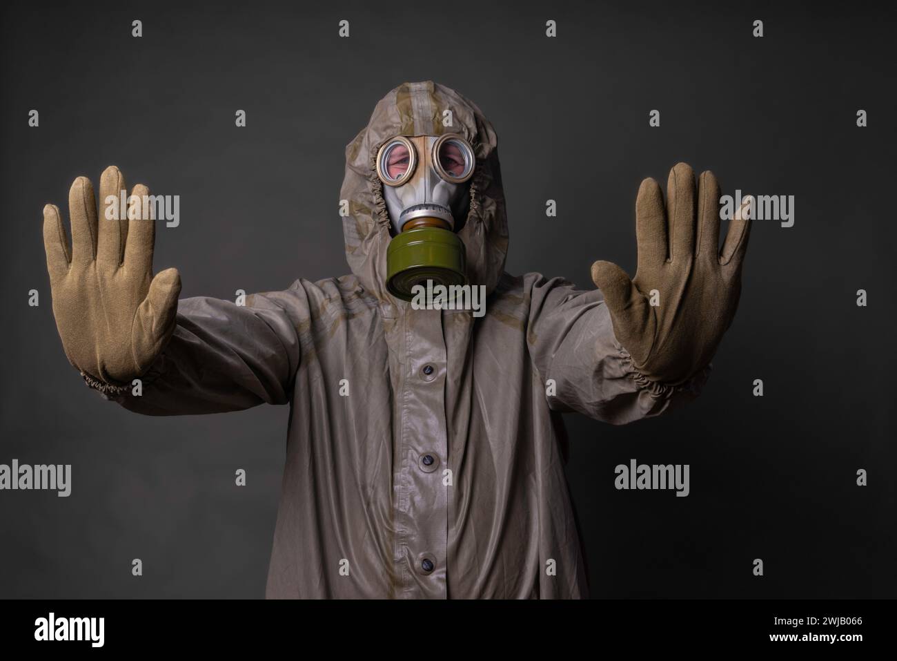 soldier in a protective suit with a gas mask during a disaster drill ...