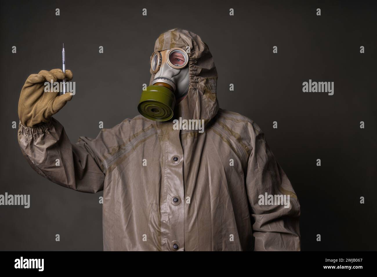 soldier in a protective suit with a gas mask during a disaster drill ...