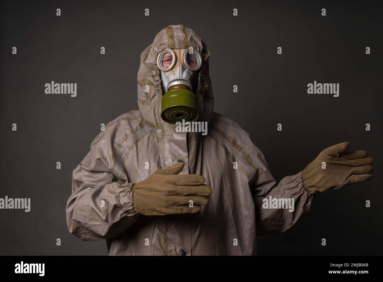 soldier in a protective suit with a gas mask during a disaster drill ...