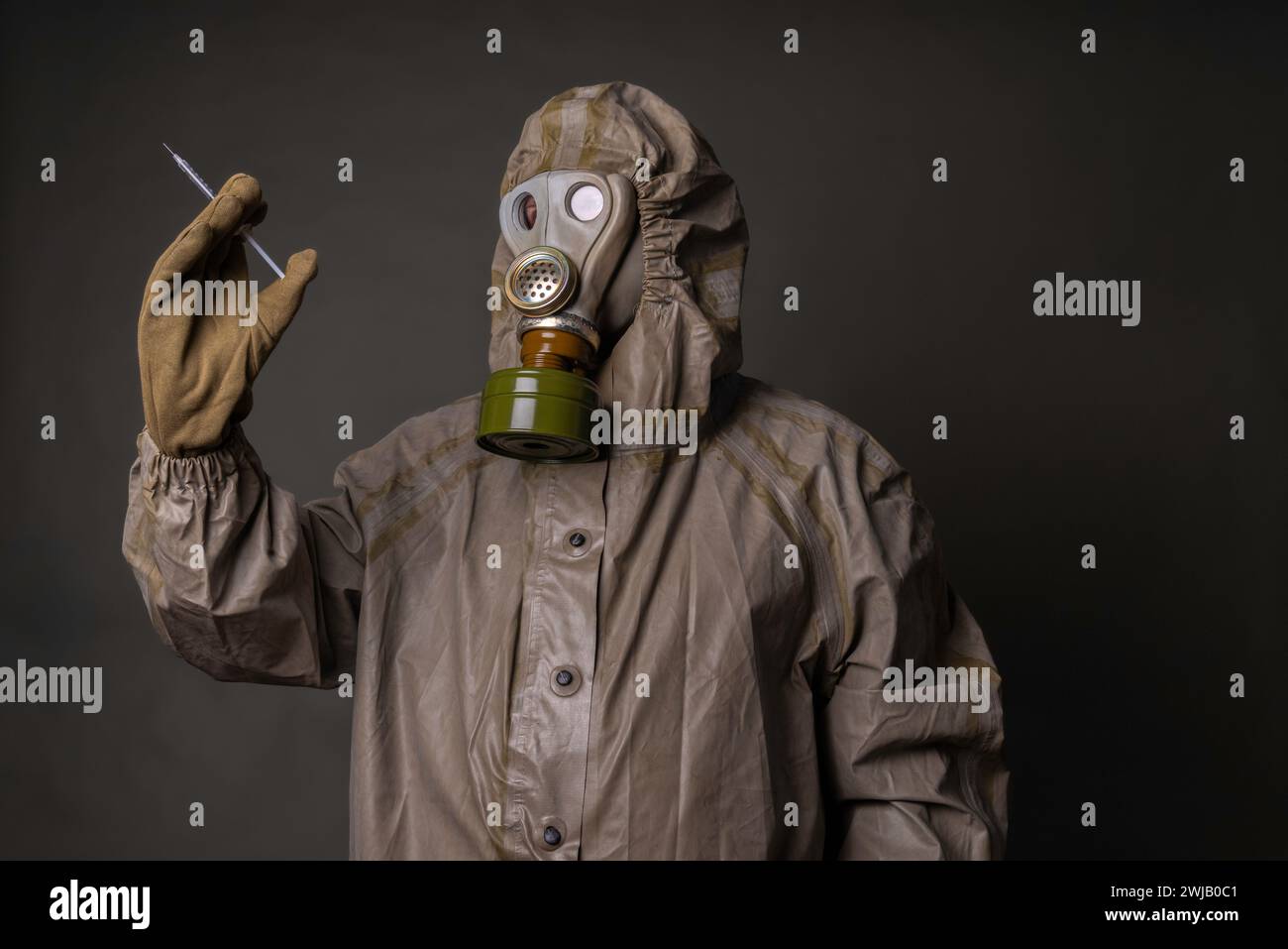 soldier in a protective suit with a gas mask during a disaster drill ...
