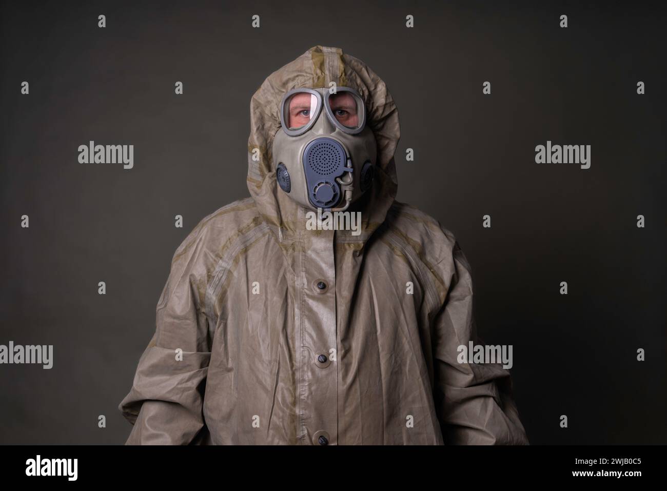 soldier in a protective suit with a gas mask during a disaster drill ...