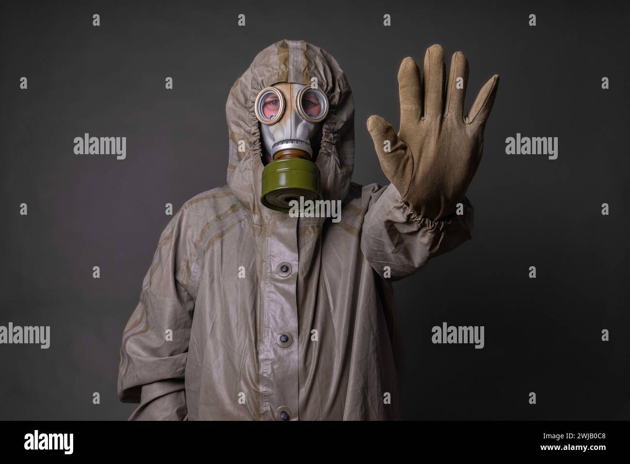 soldier in a protective suit with a gas mask during a disaster drill ...