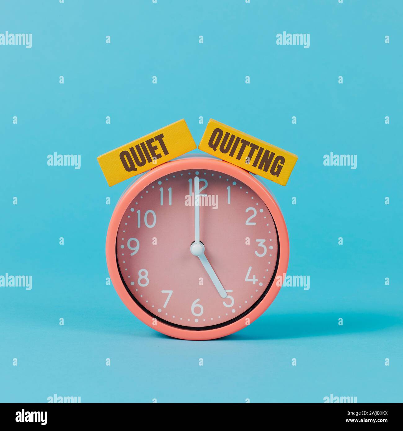 the text quiet quitting written on two yellow rectangular pieces, on a ...