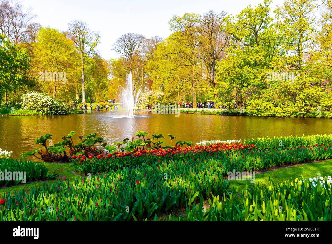 Lake River with beautiful well Fountain in the park with people and ...