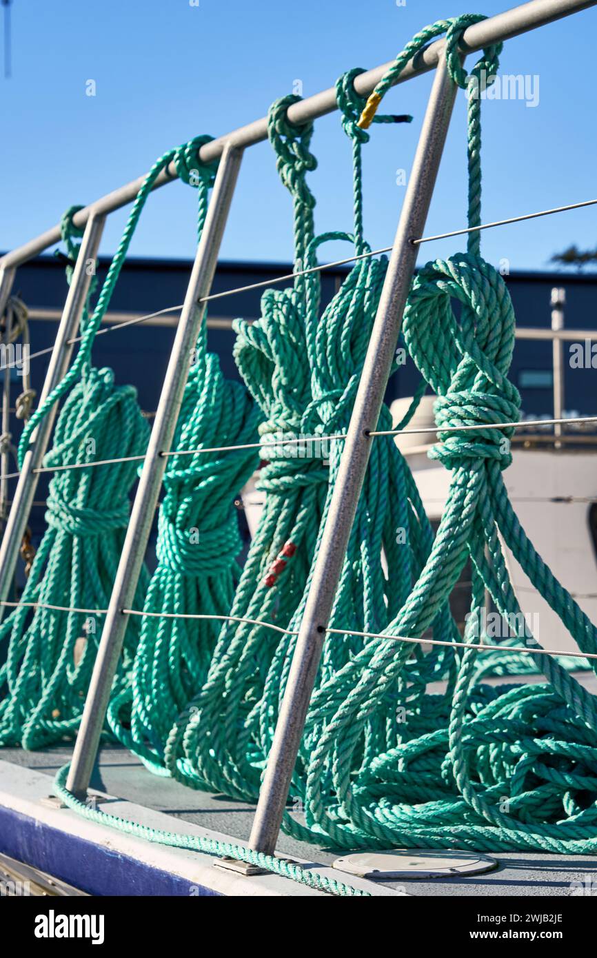 Bright green lines used for fish traps tied to the railing on a ...