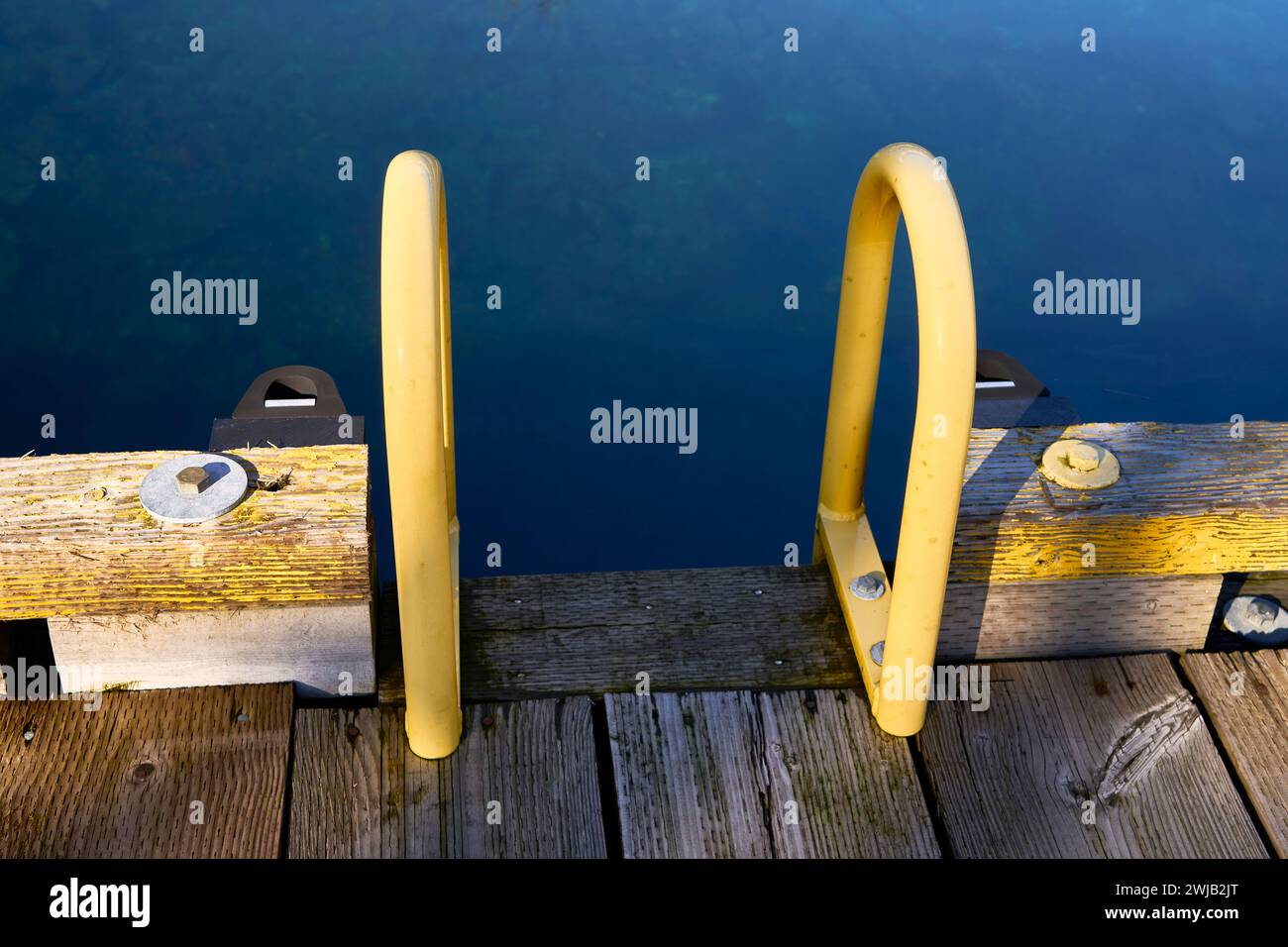 A yellow rescue, safety ladder that extends down into the ocean on a ...