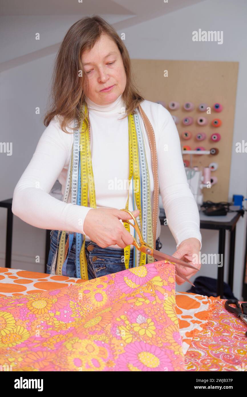 Fashion designer woman working on a new collection of clothes in her ...