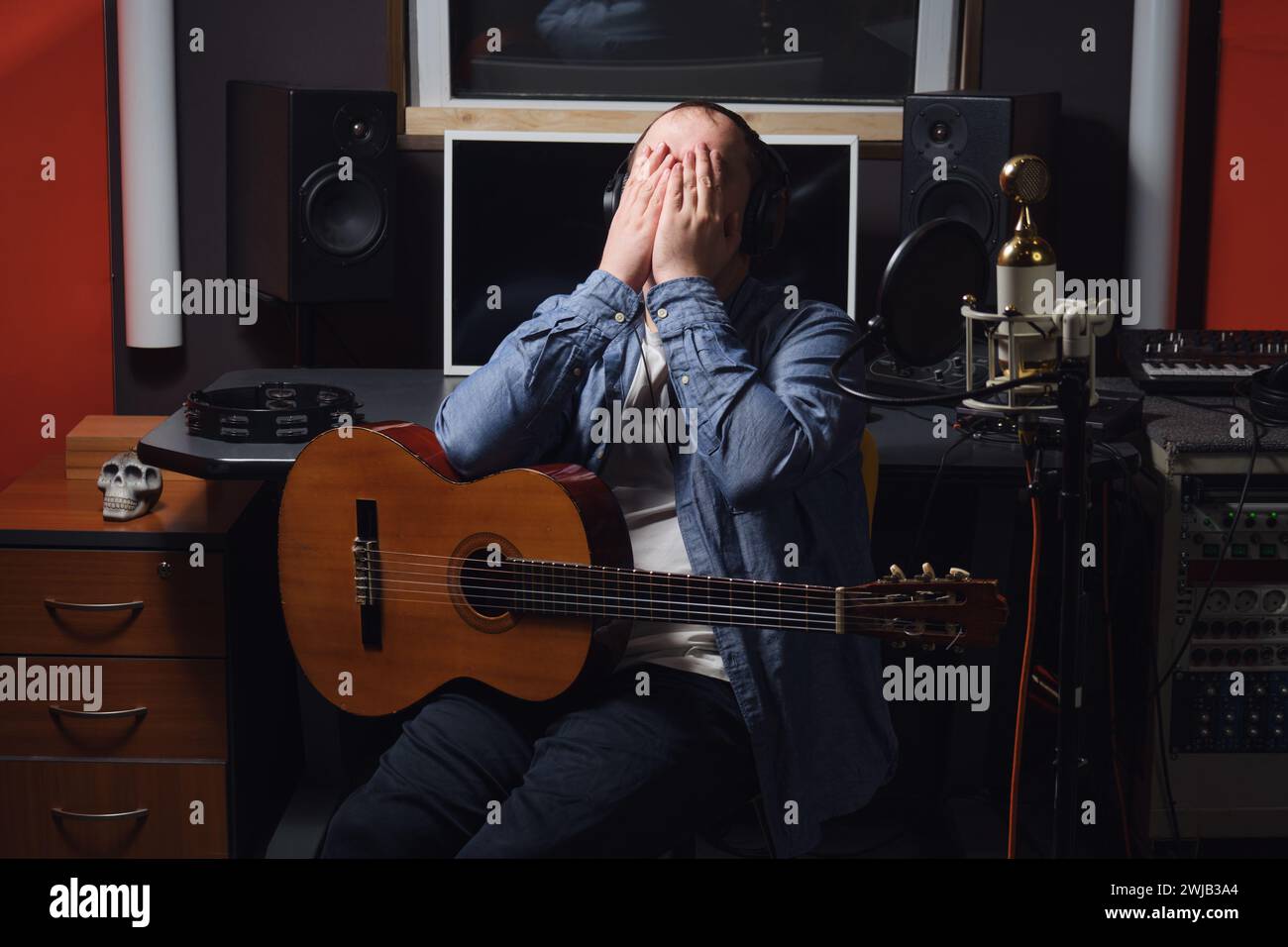 A crying musician in a recording studio. The workplace of a sound ...