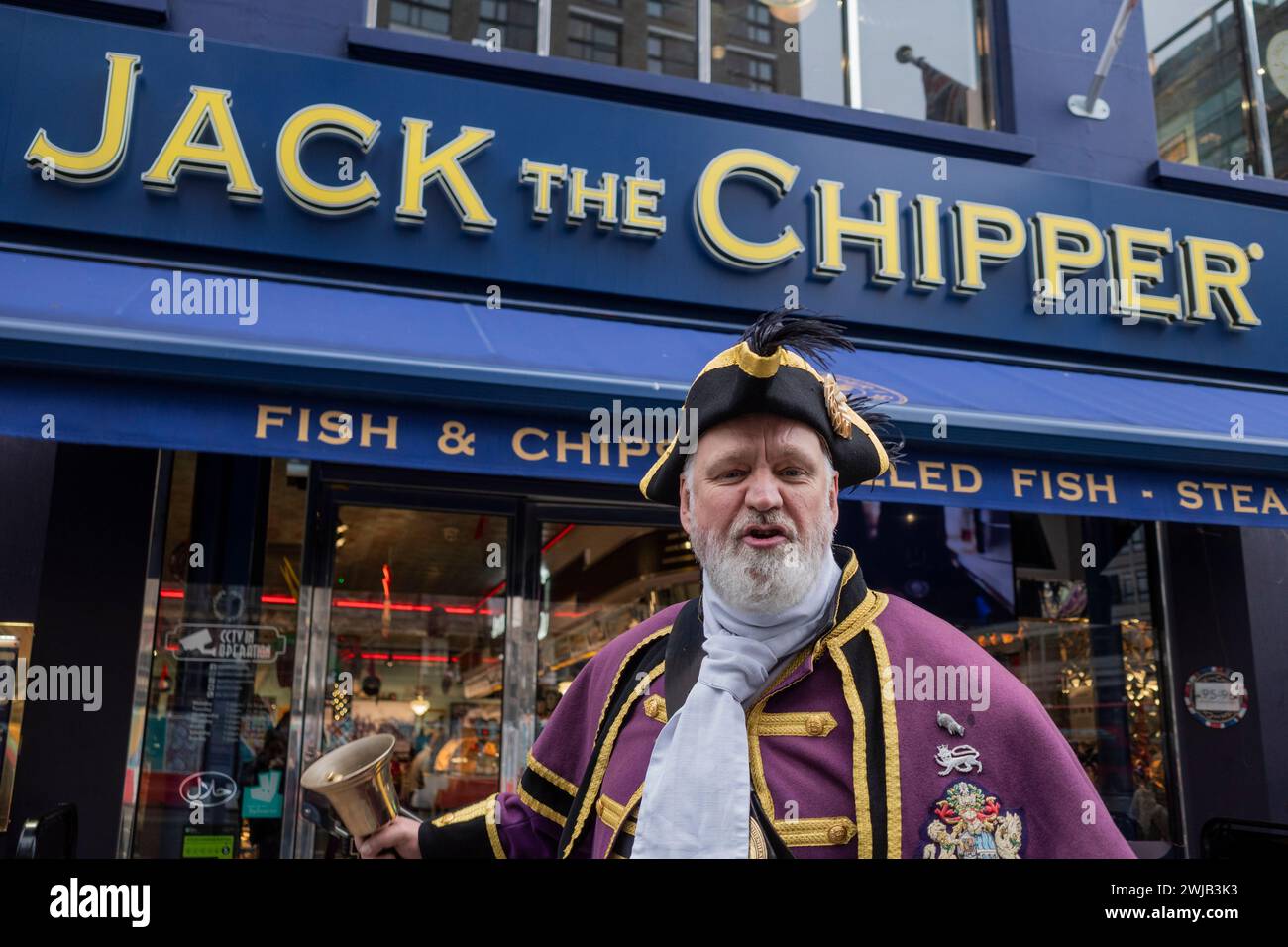London, UK 14 February 2024. A fully costumed professional town crier ...